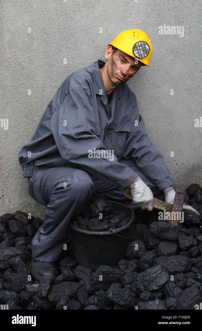 Miner hammer smashing a stone coal Stock Photo - Alamy