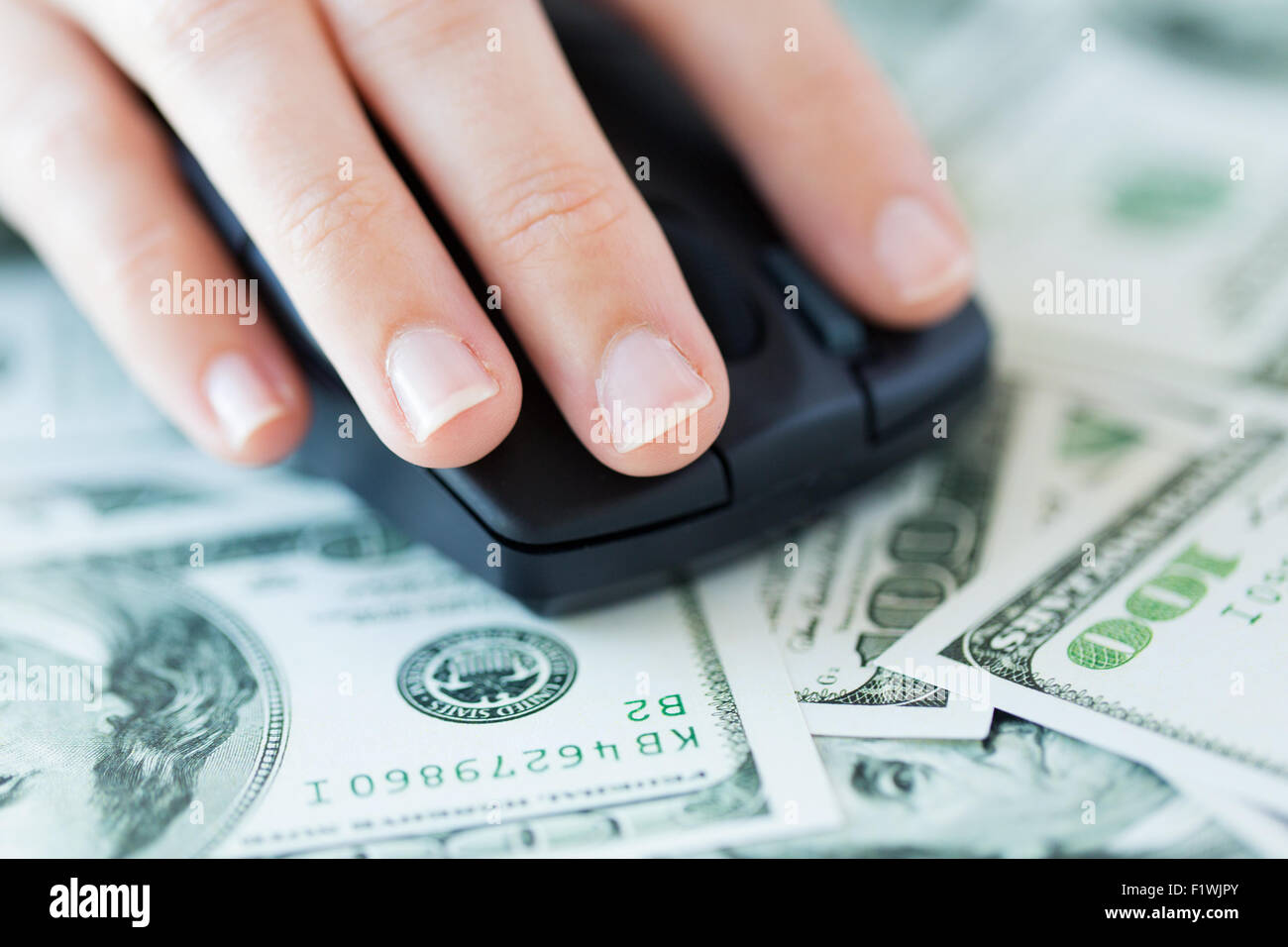 close up of hand with computer mouse on money Stock Photo - Alamy