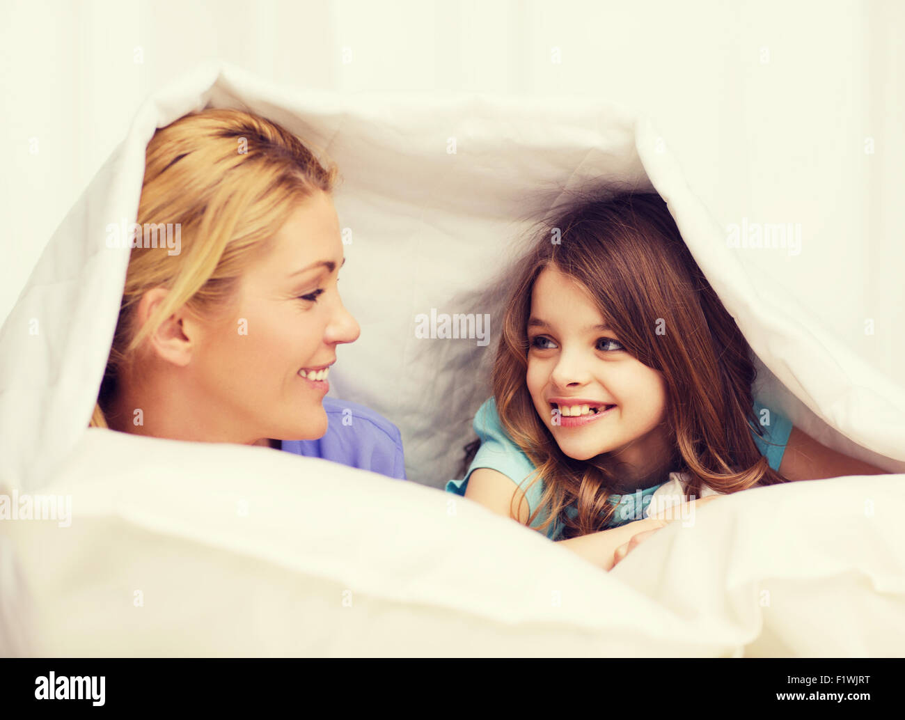 mother and little girl under blanket at home Stock Photo - Alamy