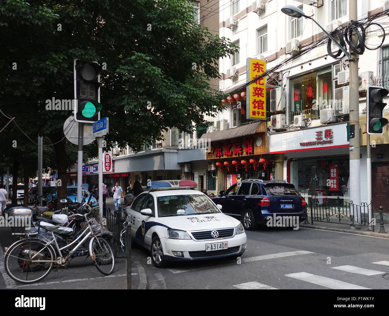 Shanghai, China. 01st Sep, 2015. A police car and a Porsche Cayenne at ...