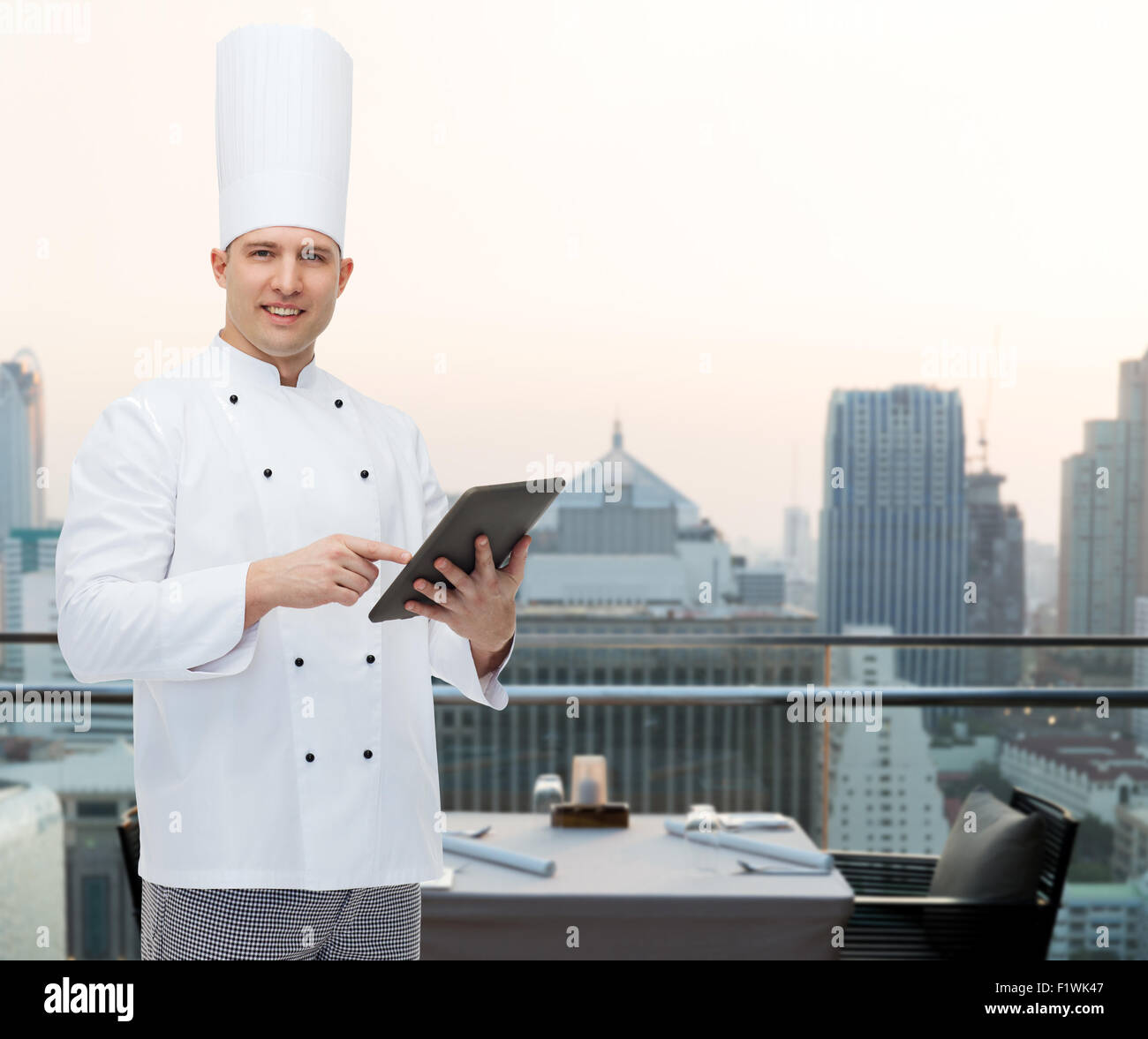happy male chef cook holding tablet pc Stock Photo - Alamy