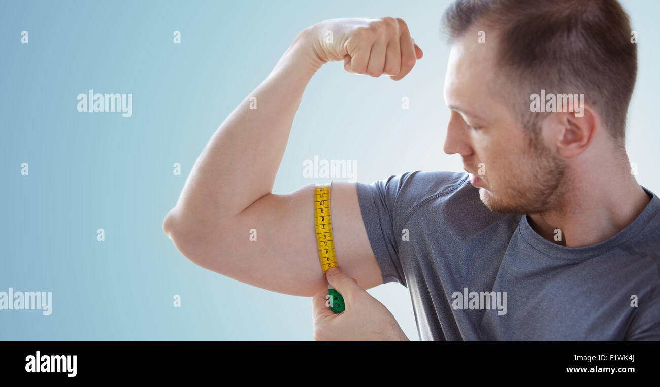 close up of male hands with tape measuring bicep Stock Photo - Alamy