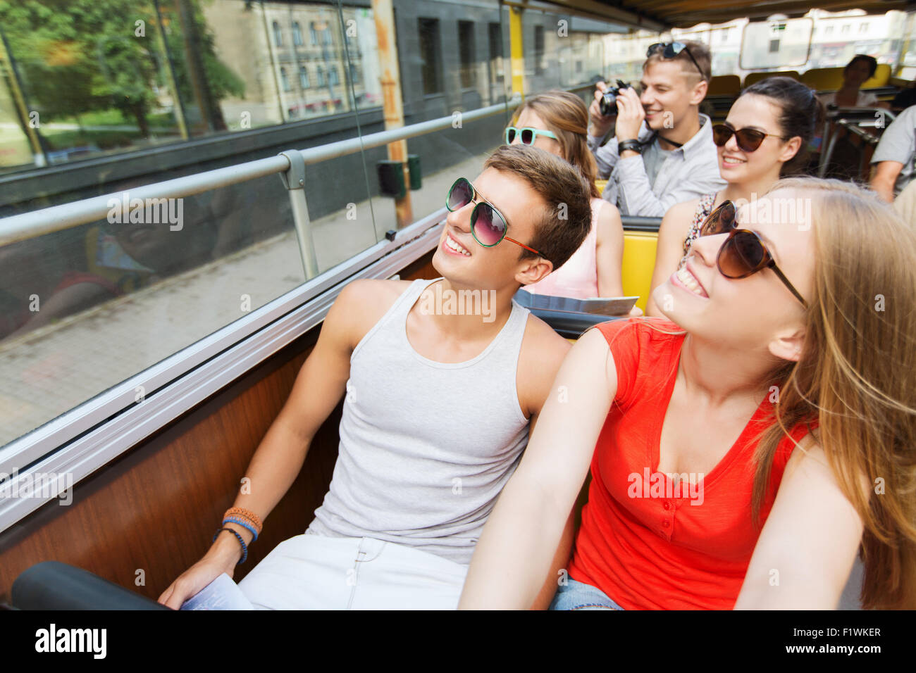 group of smiling friends traveling by tour bus Stock Photo - Alamy