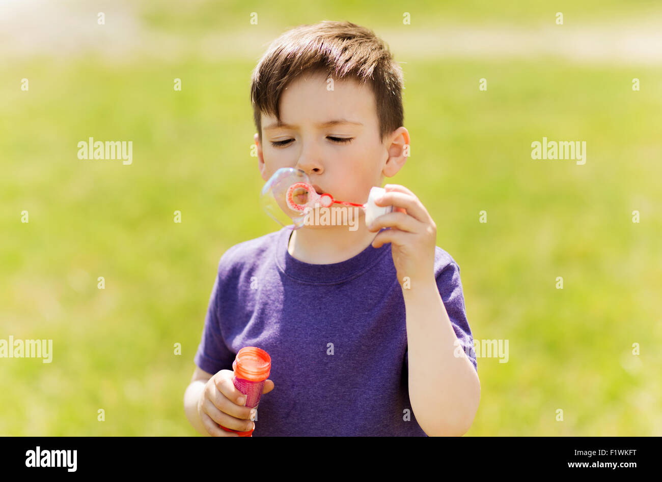 little boy blowing soap bubbles outdoors Stock Photo - Alamy