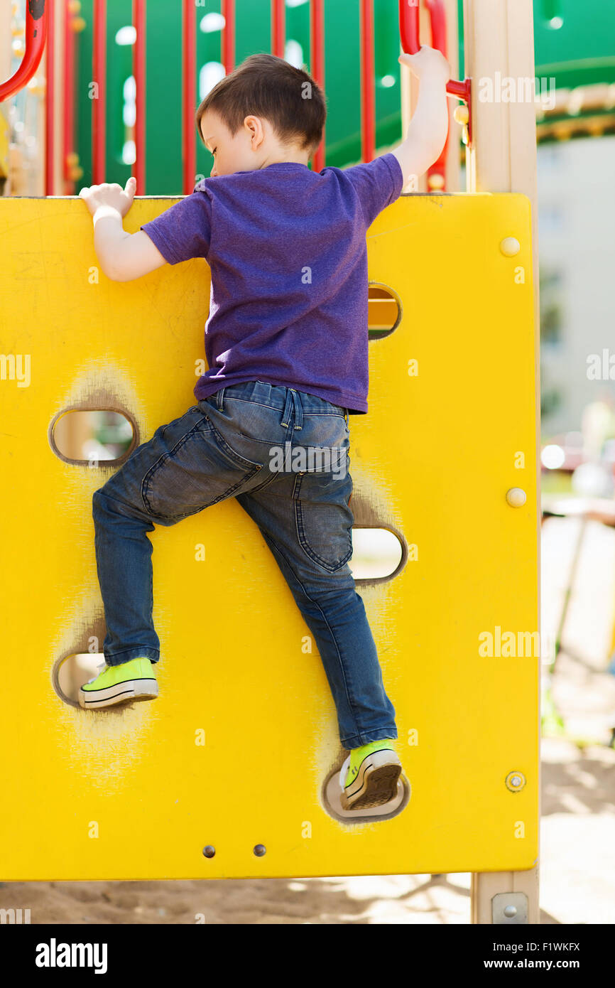 happy little boy climbing on children playground Stock Photo - Alamy