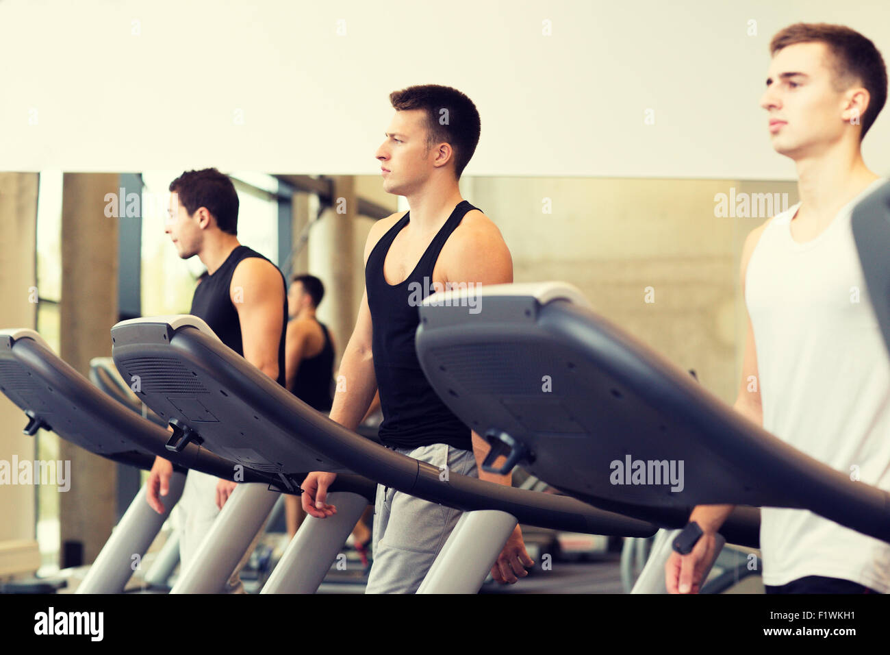 group of men exercising on treadmill in gym Stock Photo - Alamy