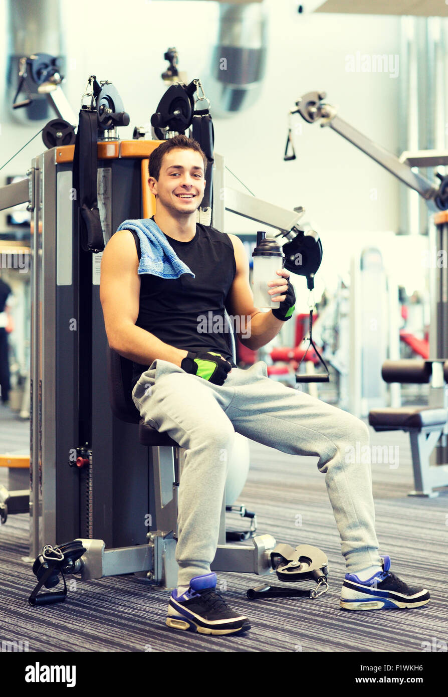smiling man exercising on gym machine Stock Photo - Alamy
