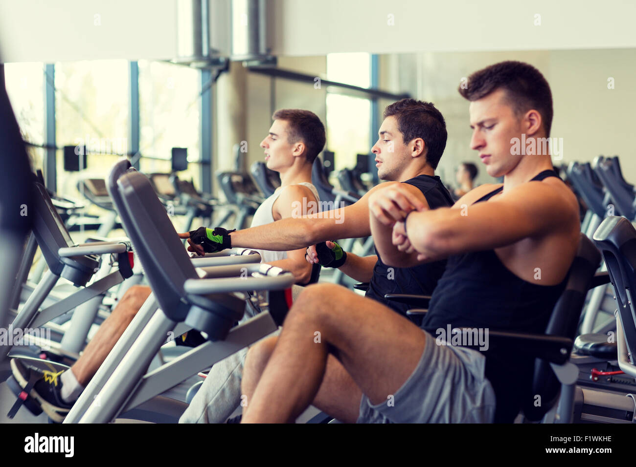 men working out on exercise bike in gym Stock Photo - Alamy