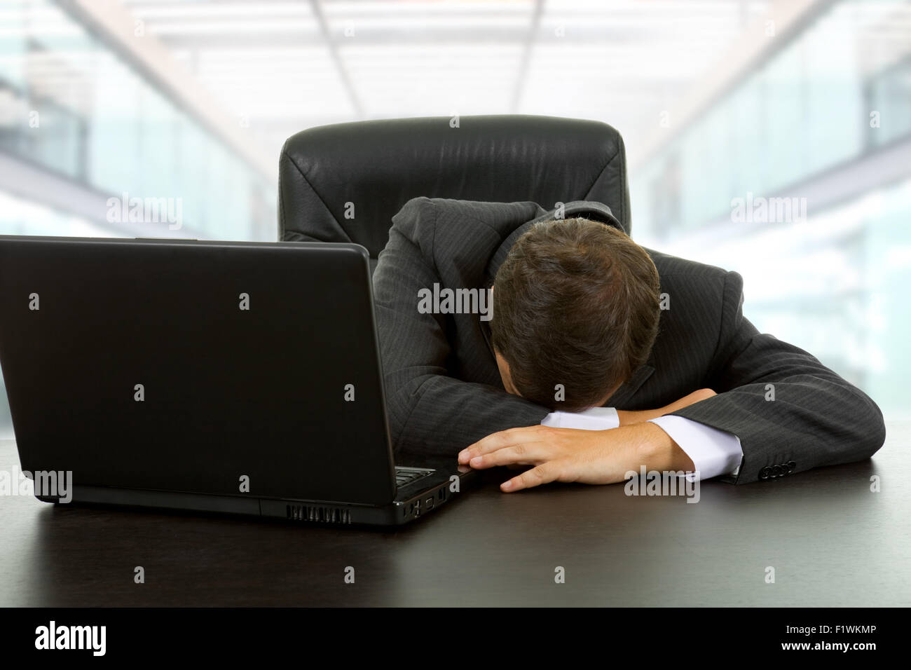 young businessman sleeping on the laptop at the office Stock Photo - Alamy
