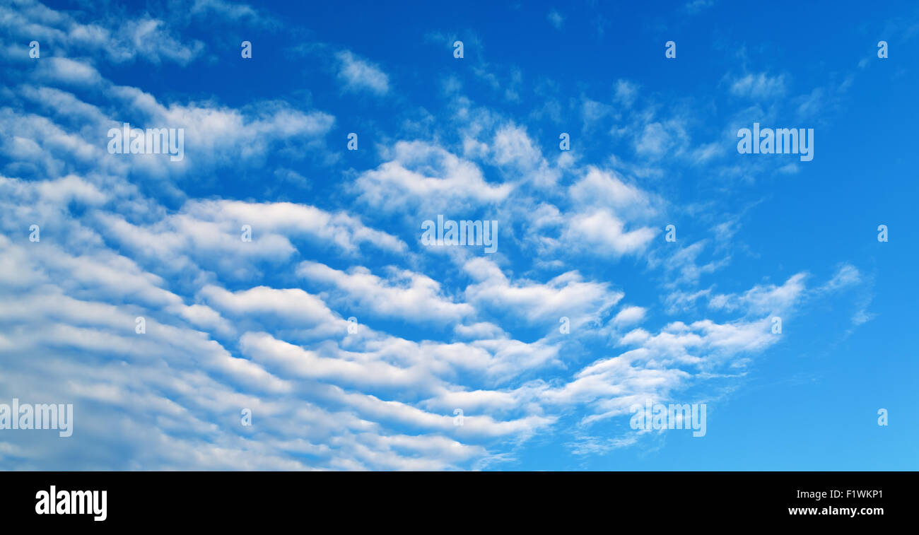 Blue sky with white cirrus clouds on a bright sunny summer day ...