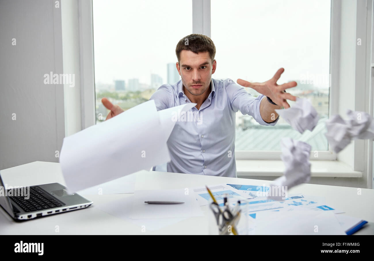 angry businessman throwing papers in office Stock Photo - Alamy