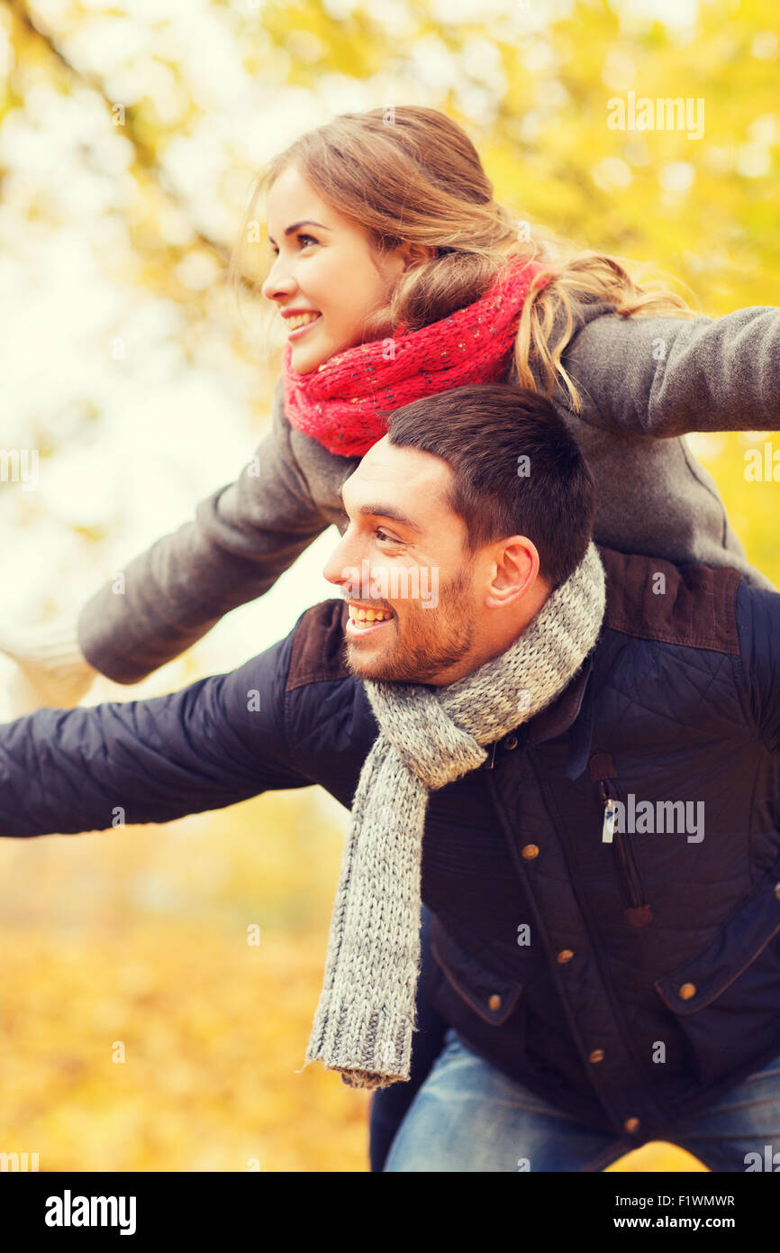 smiling couple having fun in autumn park Stock Photo - Alamy