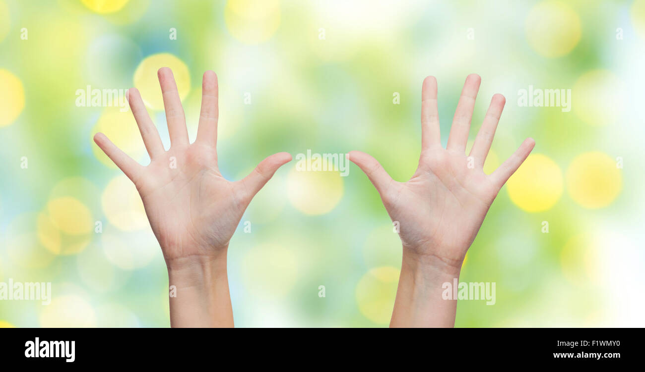 two woman hands making high five over blue sky Stock Photo - Alamy