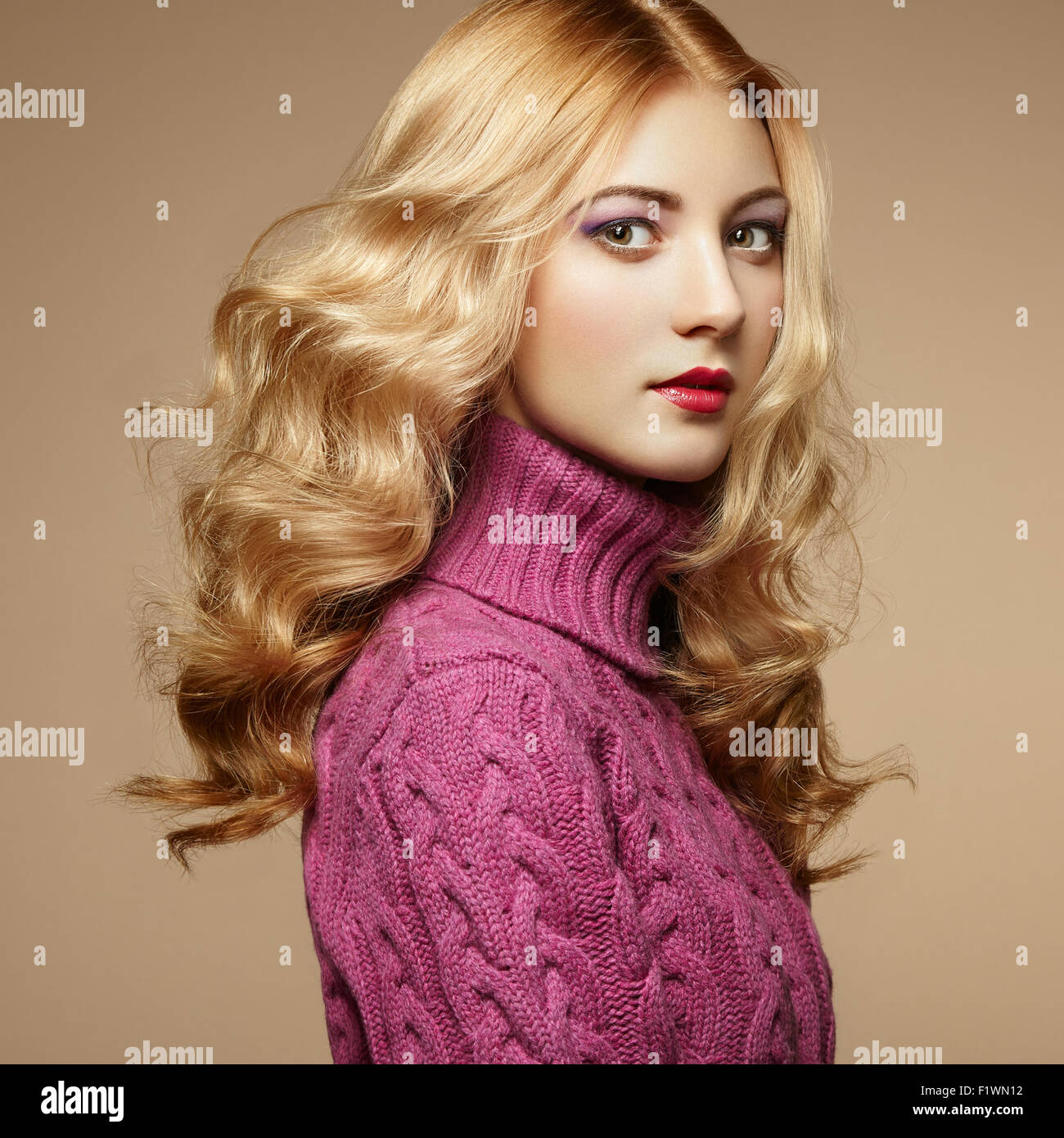 Fashion photo of beautiful woman in sweater. Curly hairstyle. Make-up ...