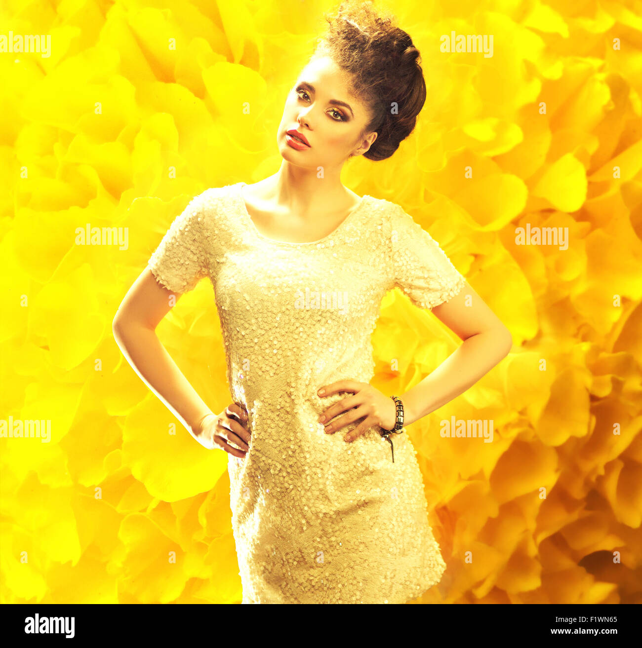 Young fresh lady over the deep yellow background Stock Photo - Alamy