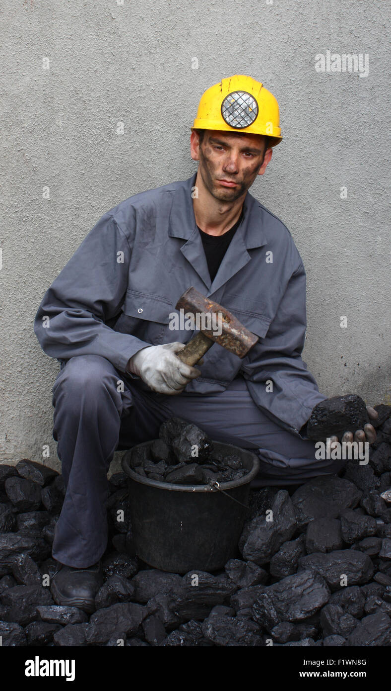 Miner hammer smashing a stone coal Stock Photo - Alamy