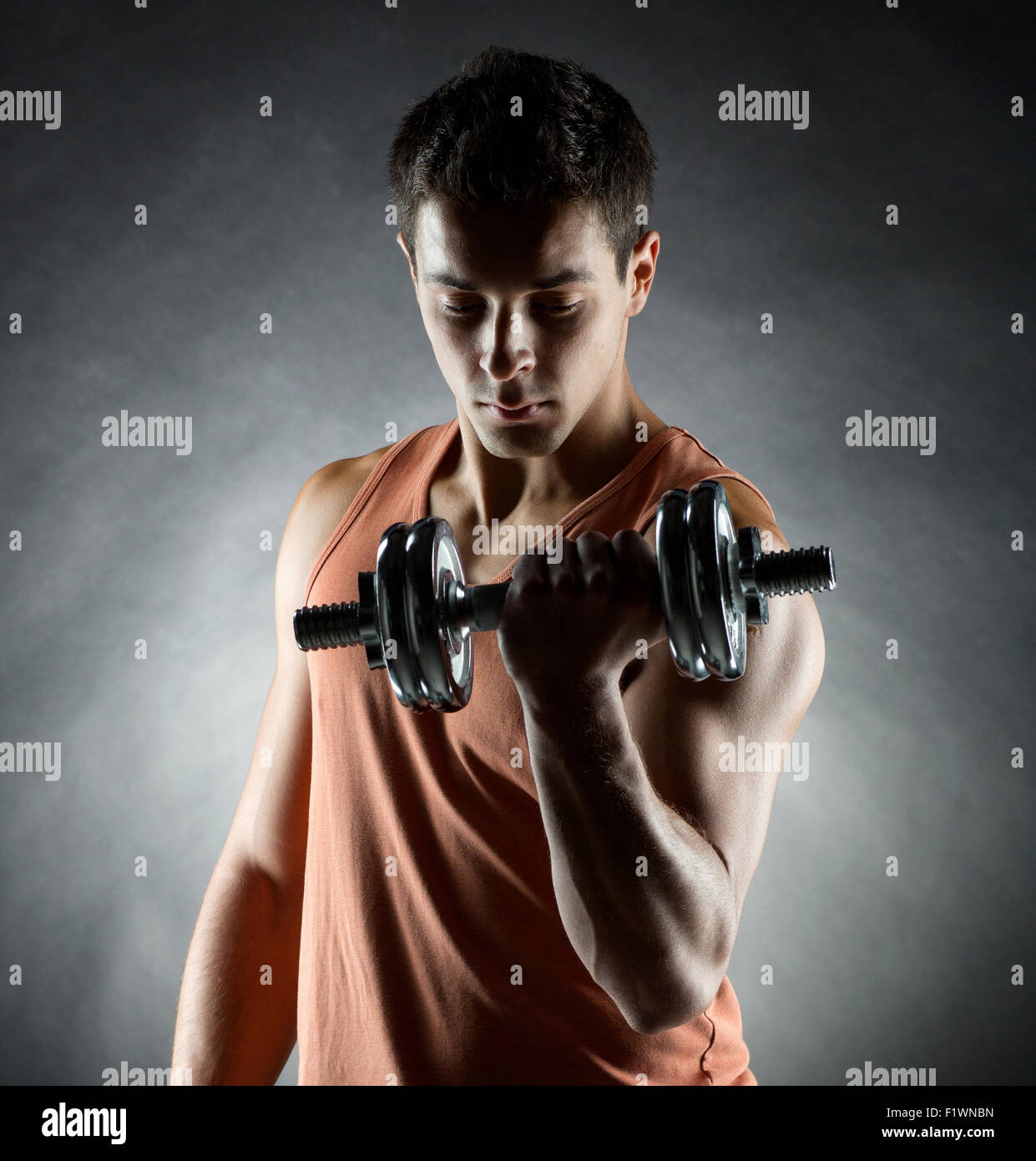 young man with dumbbell Stock Photo - Alamy