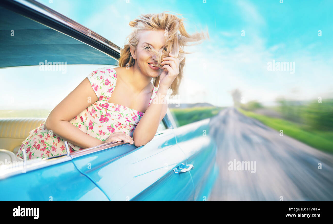 Blond woman during the fast ride Stock Photo - Alamy
