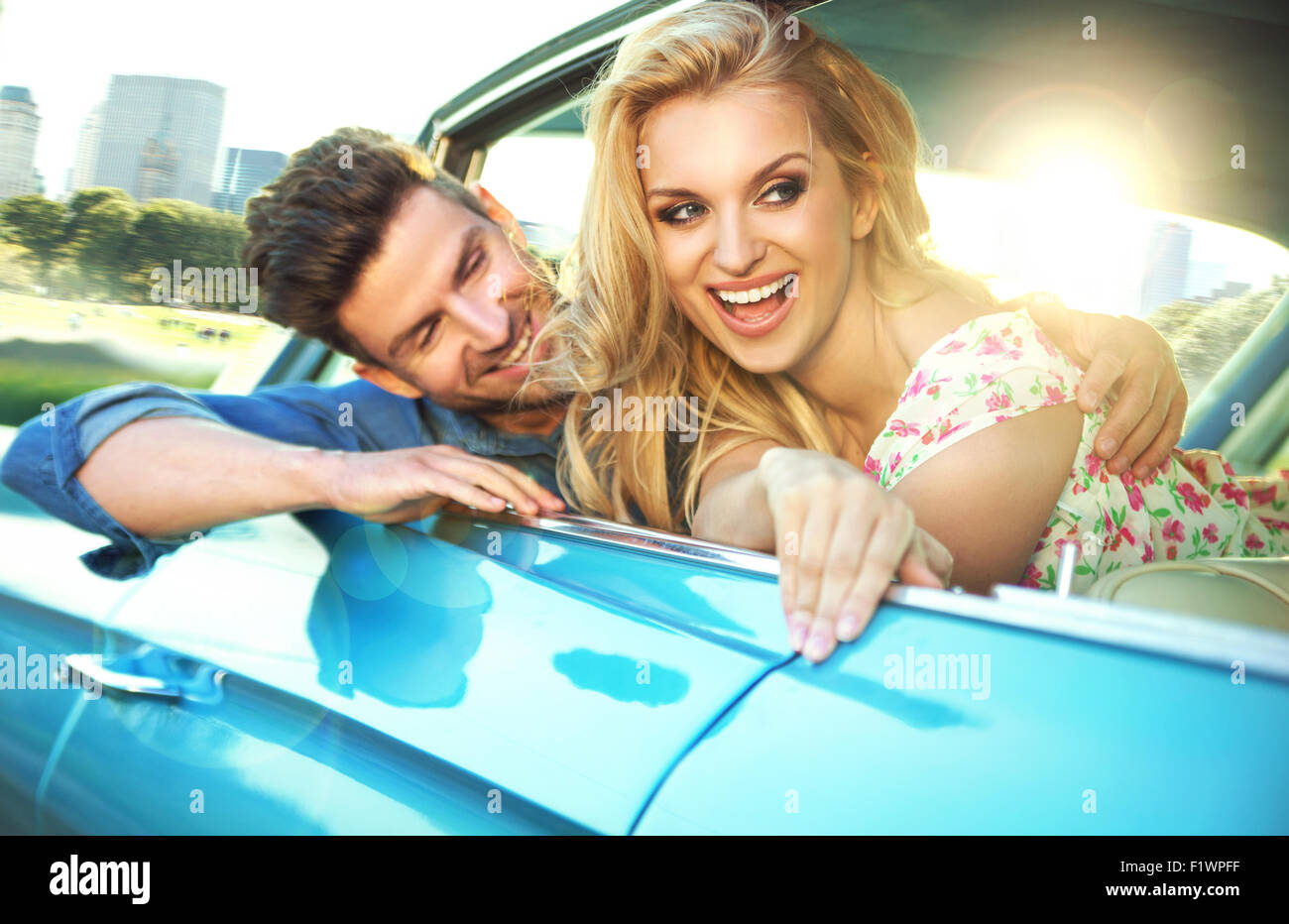 Cheerful couple enjoying the fast ride Stock Photo - Alamy