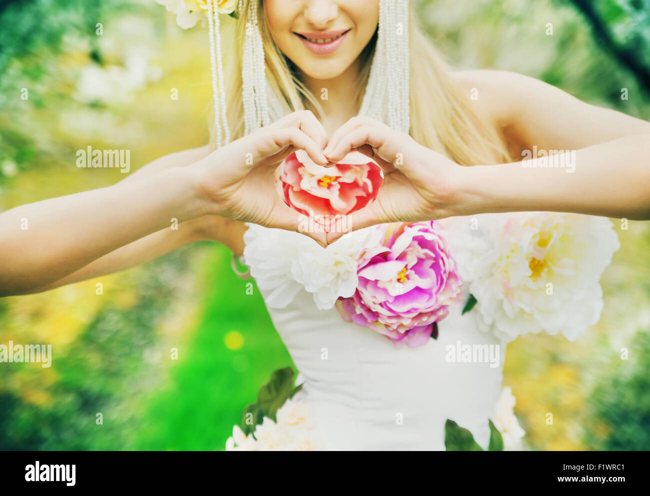 Fresh young woman making the heart sign Stock Photo - Alamy