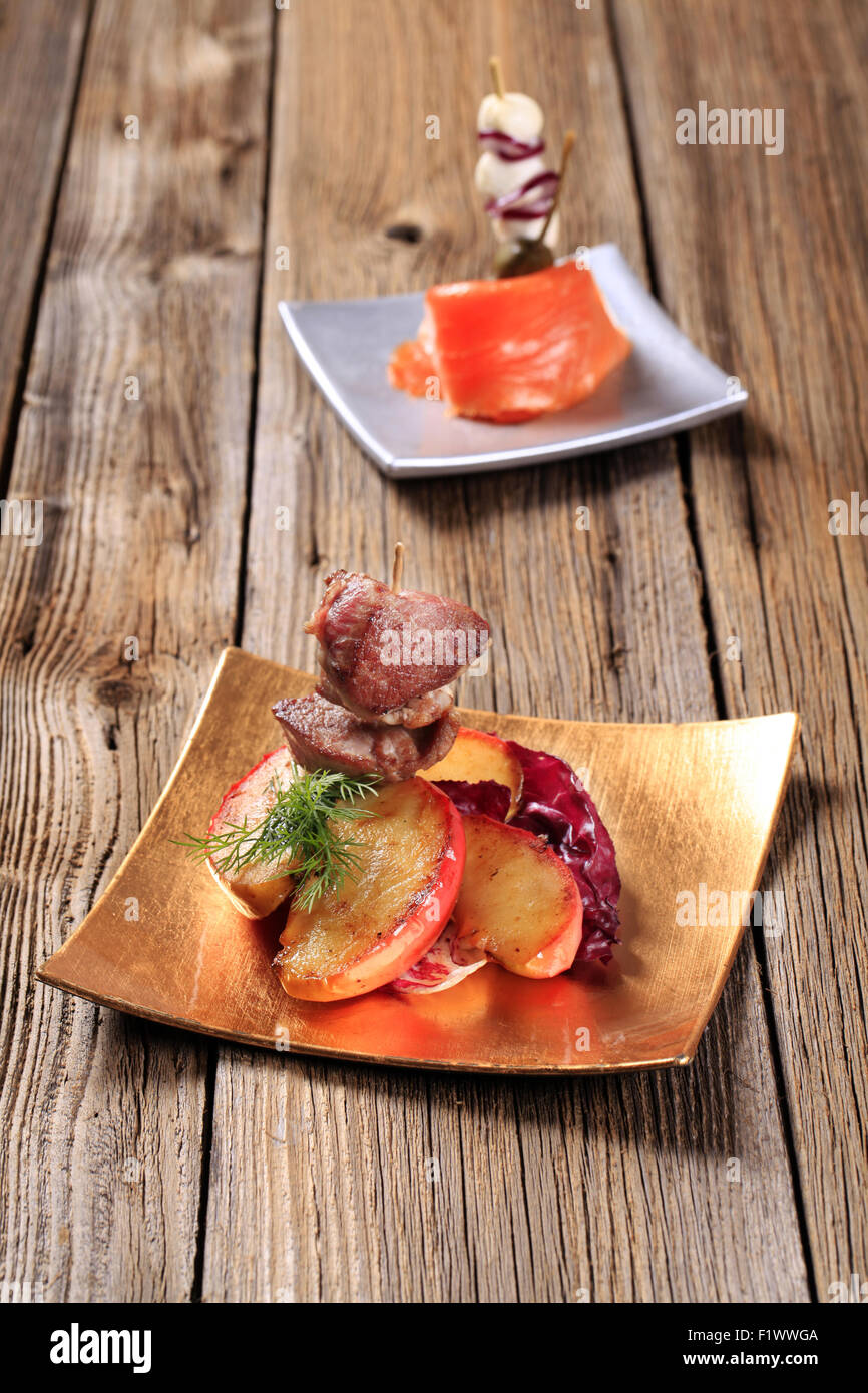 Roasted meat on stick and slices of apple Stock Photo - Alamy