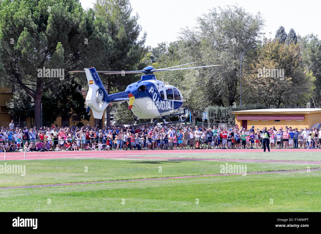 Unidentified people are watching a helicopter landing, of spanish ...