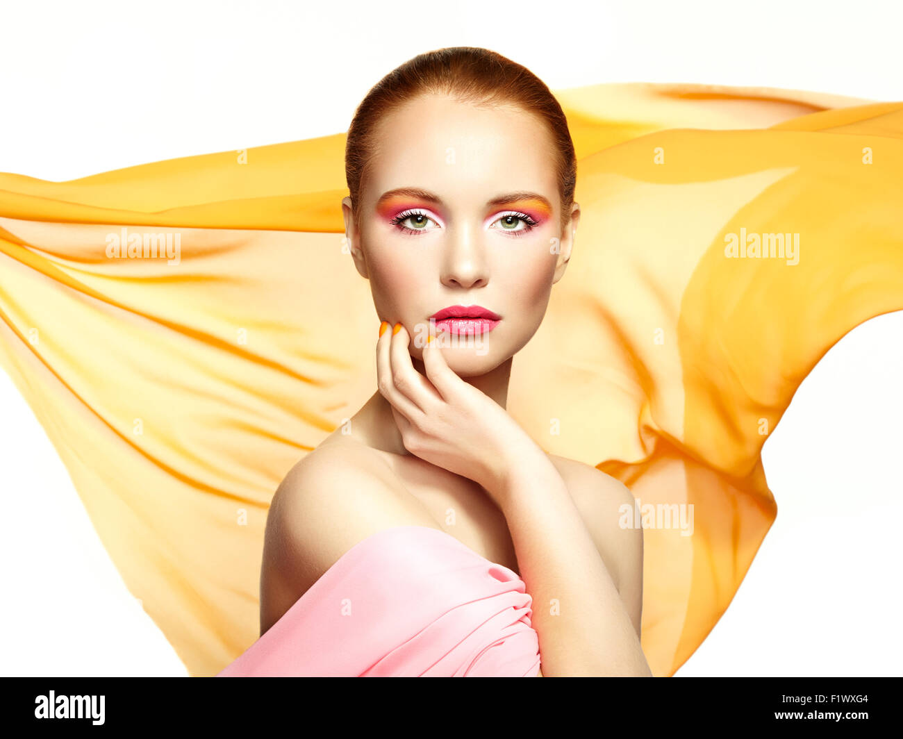 Portrait of young beautiful woman against flying fabric. Beauty woman ...