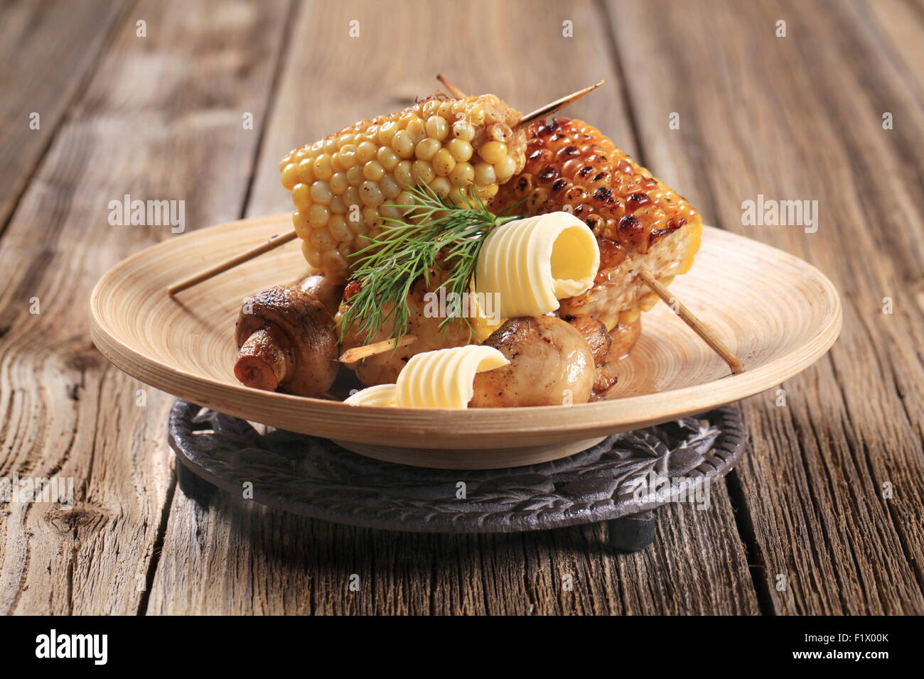 Roasted sweet corn cobs and button mushrooms Stock Photo - Alamy