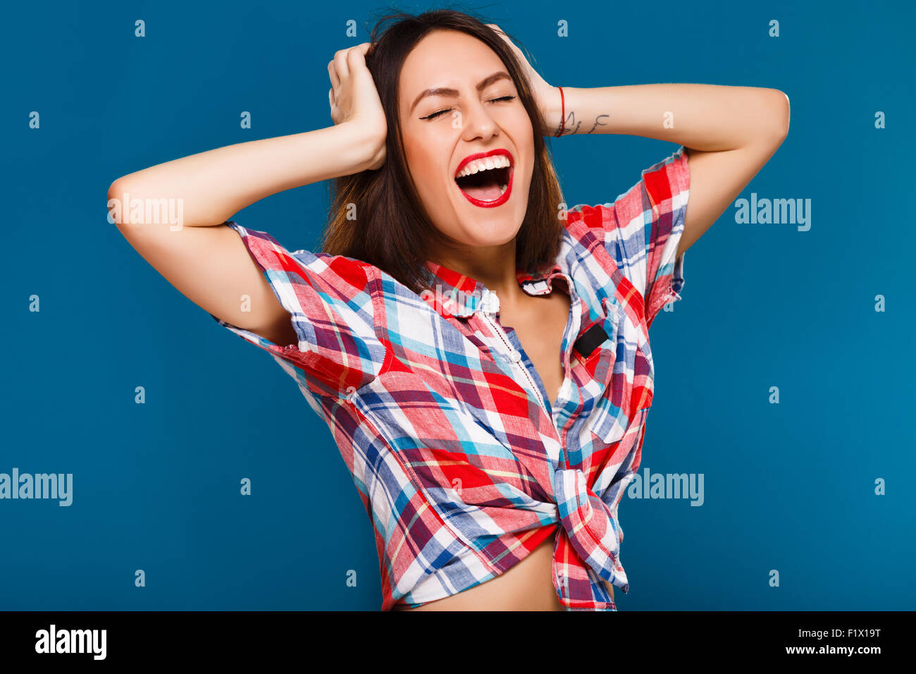 Attractive girl, screaming on blue background in studio Stock Photo - Alamy