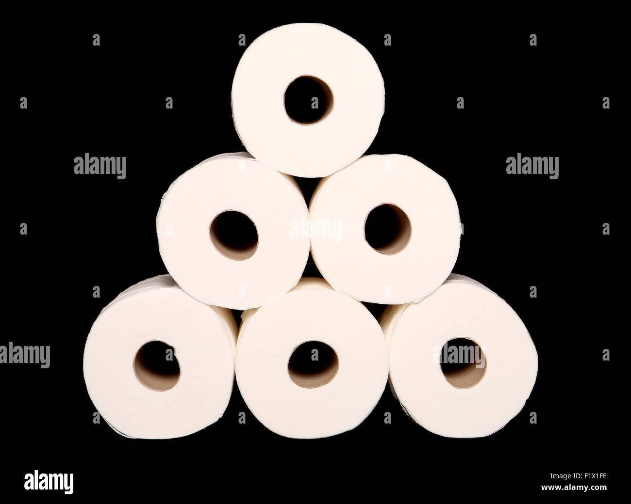 stack of toilet paper rolls on black background Stock Photo - Alamy