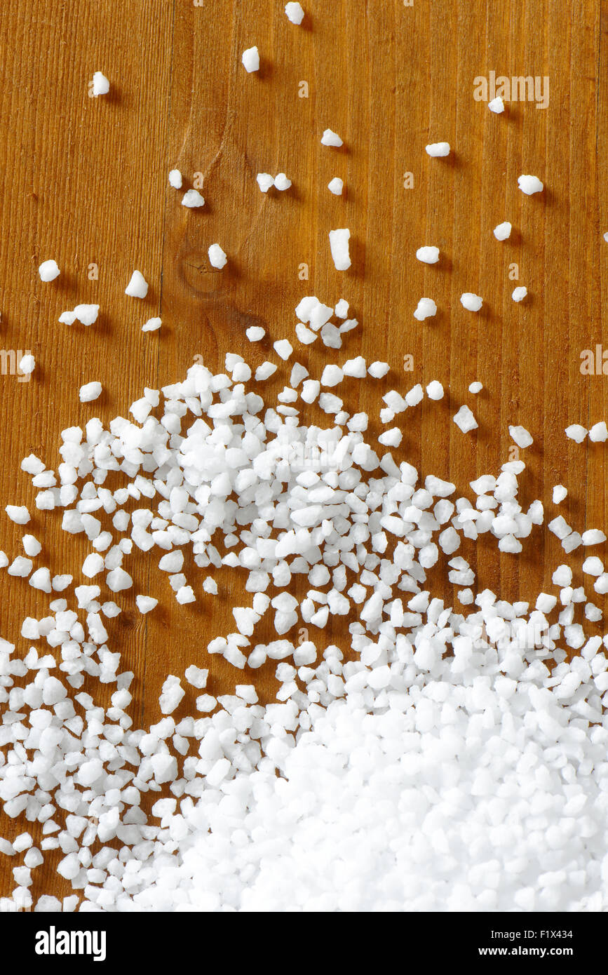 handful of salt crystals on the wooden table Stock Photo - Alamy