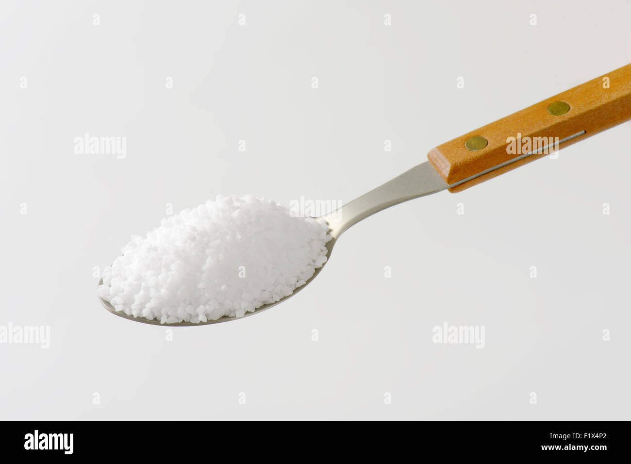 Spoonful of coarse ground salt Stock Photo - Alamy
