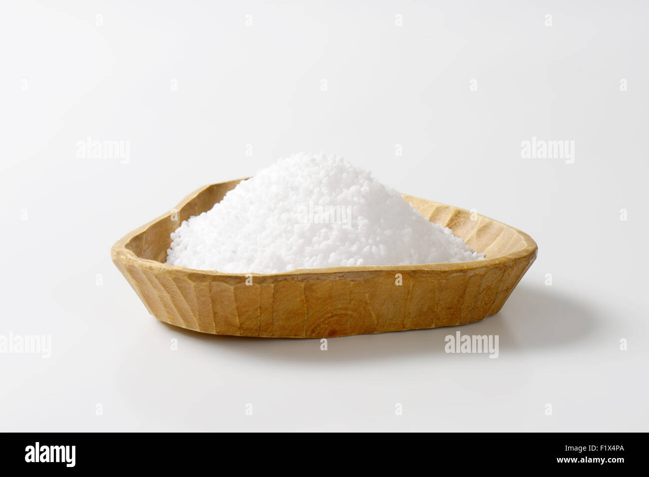 Coarse grained salt in triangle wooden bowl Stock Photo - Alamy