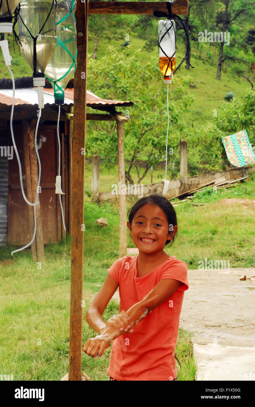 Guatemala, Salama, girl washing hands at school out of bottles (Wendy ...