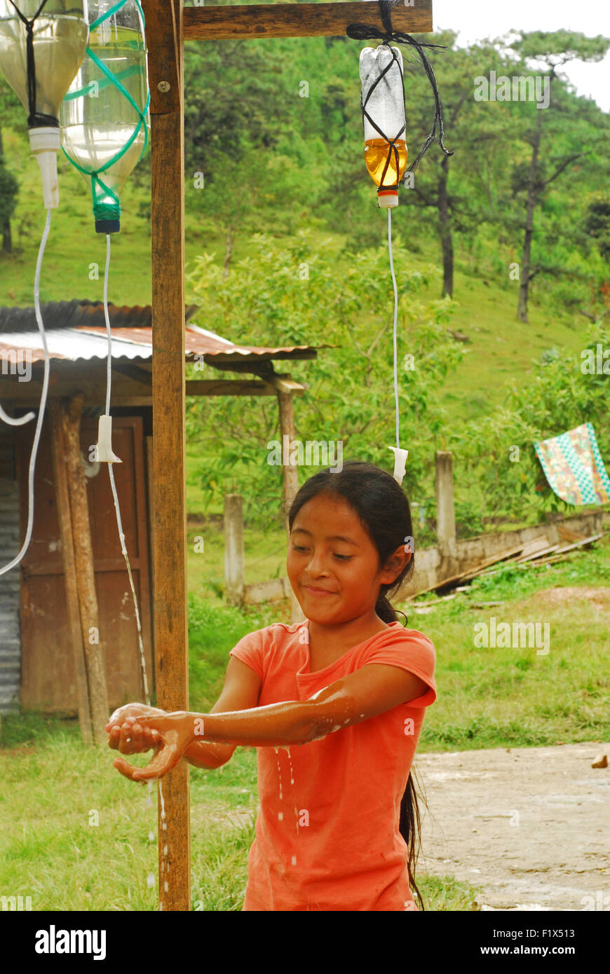 Guatemala, Salama, girl washing hands at school out of bottles (Wendy ...