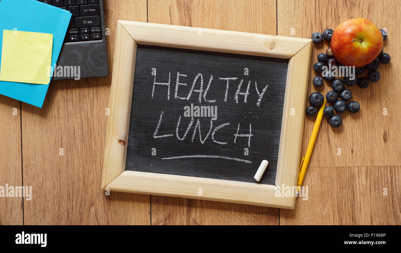 Healthy lunch written on a chalkboard at the office Stock Photo - Alamy