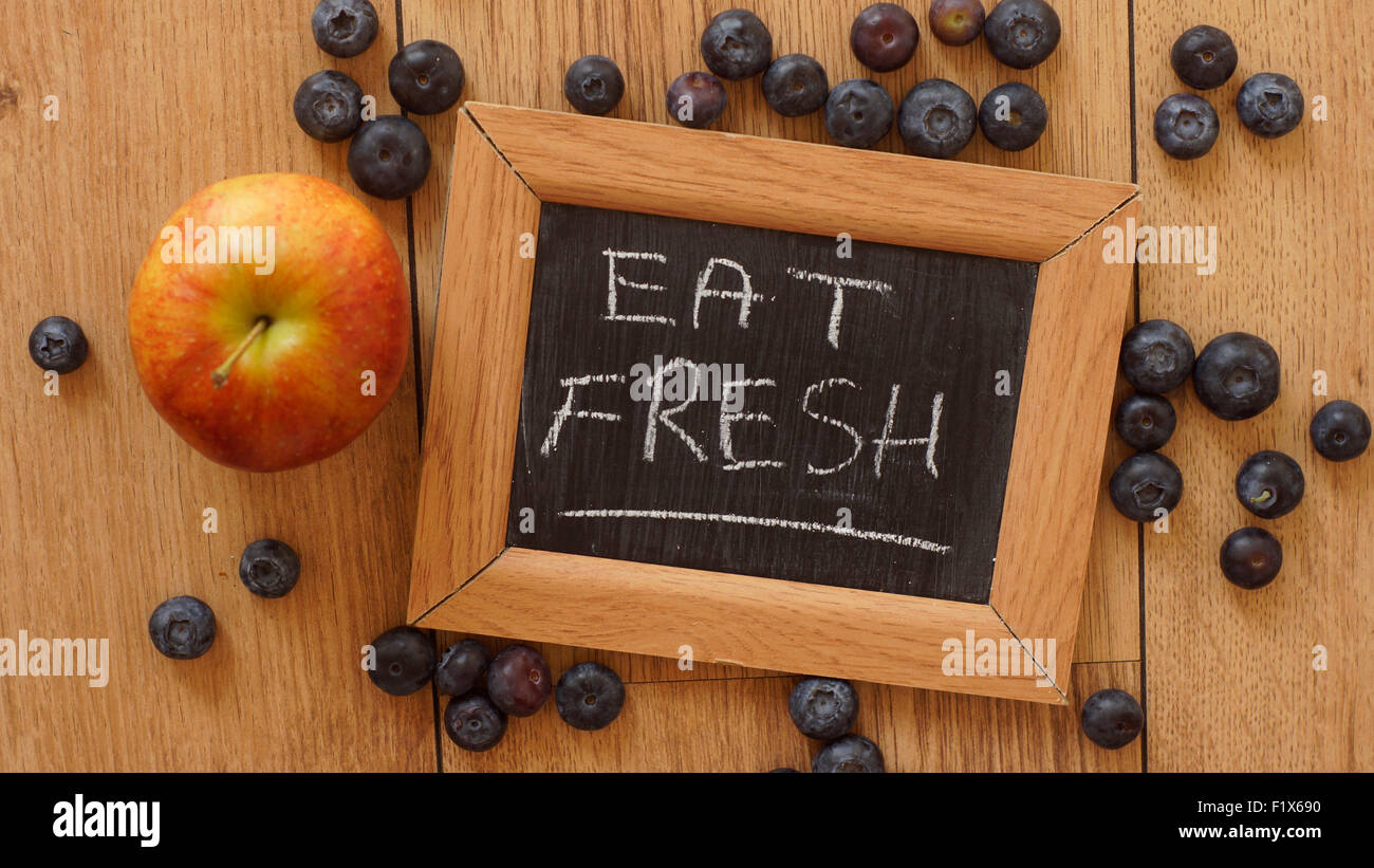 Eat fresh written on a chalkboard at the office Stock Photo - Alamy