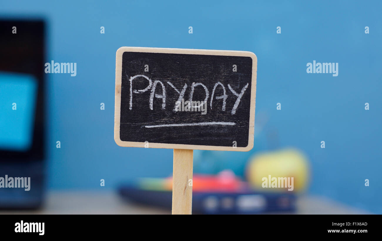 Payday written at the office Stock Photo - Alamy