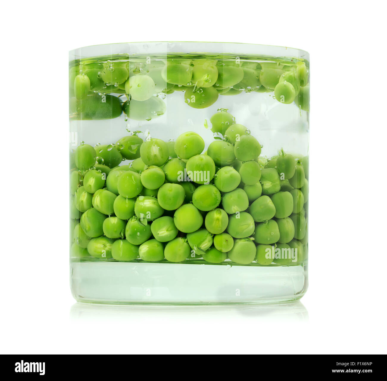 green peas in the water on the the white background Stock Photo - Alamy