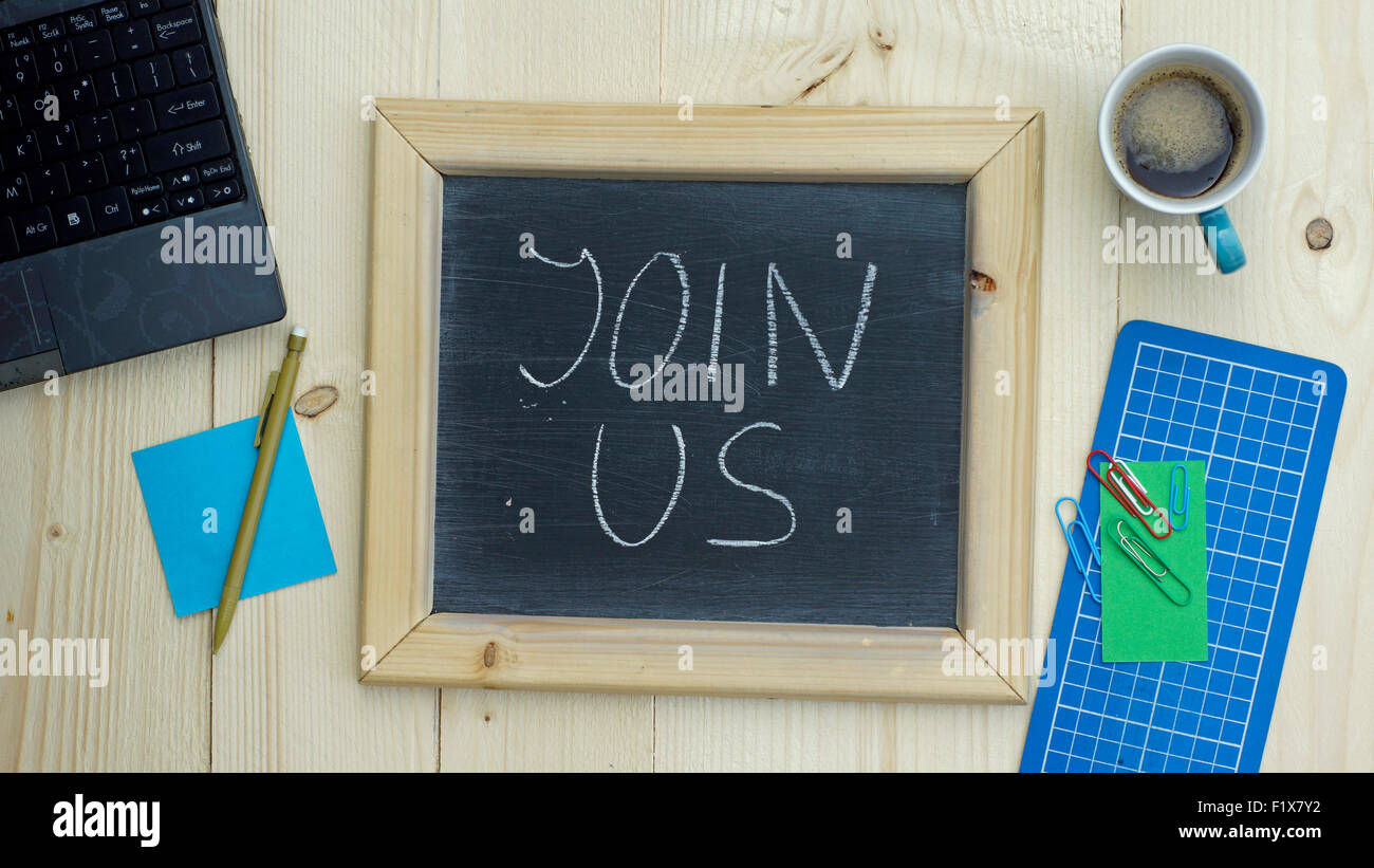 Join us written on a chalkboard at the office Stock Photo - Alamy