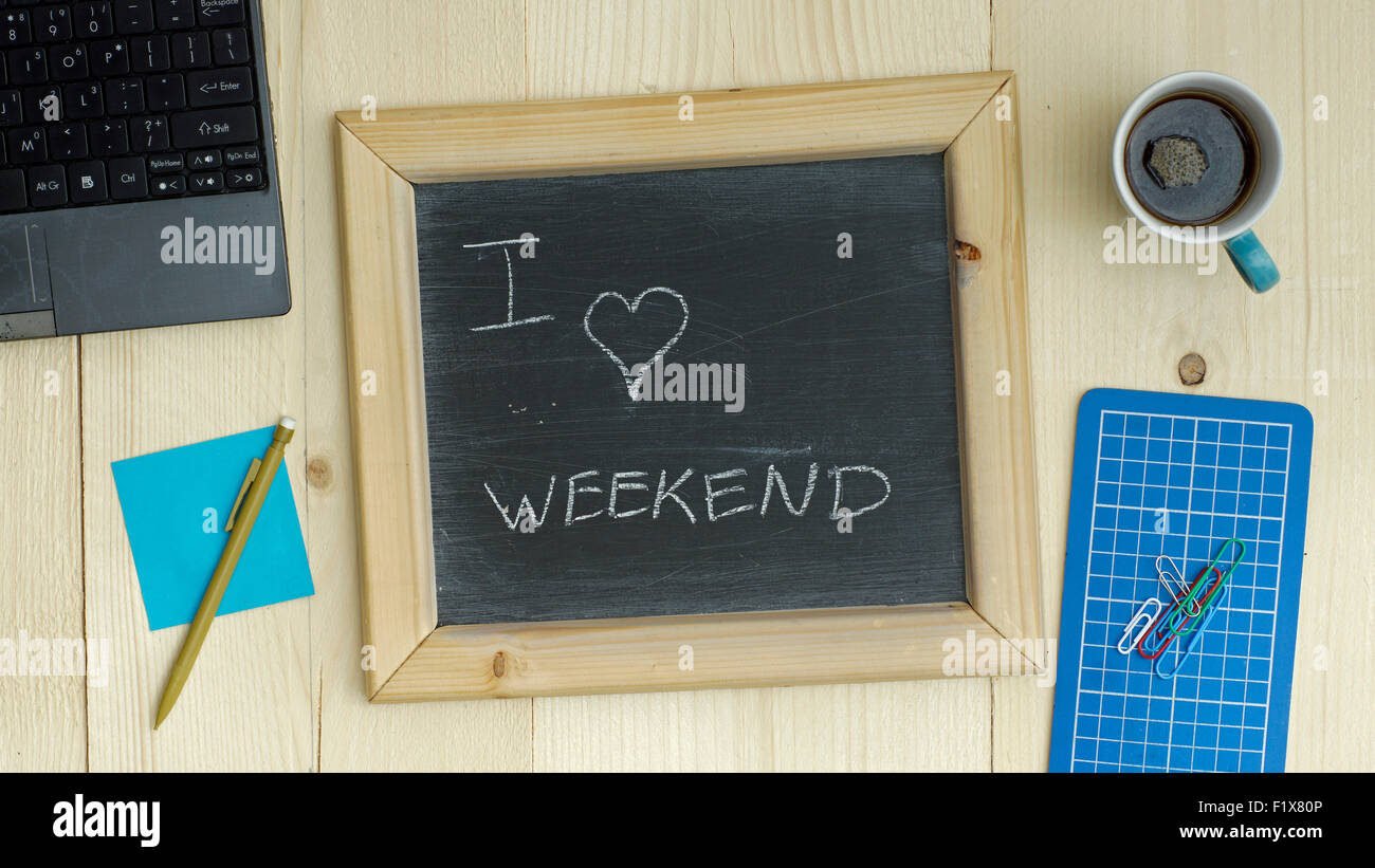 I love weekend written on a chalckboard at the office Stock Photo - Alamy
