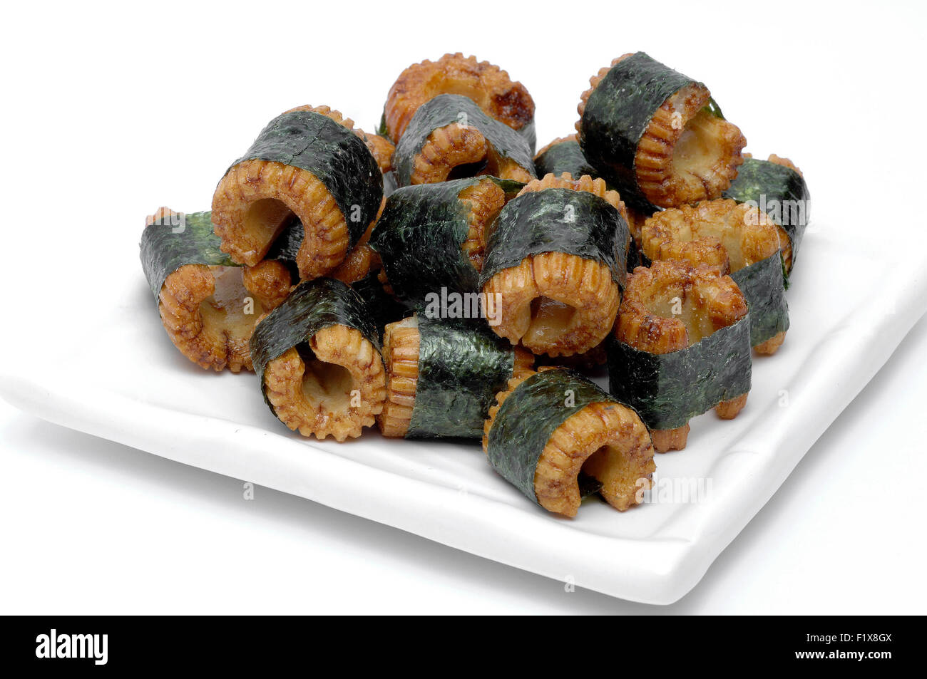 Sushi-shaped, small pastry pieces, wrapped with seaweed, seaweed, and a ...