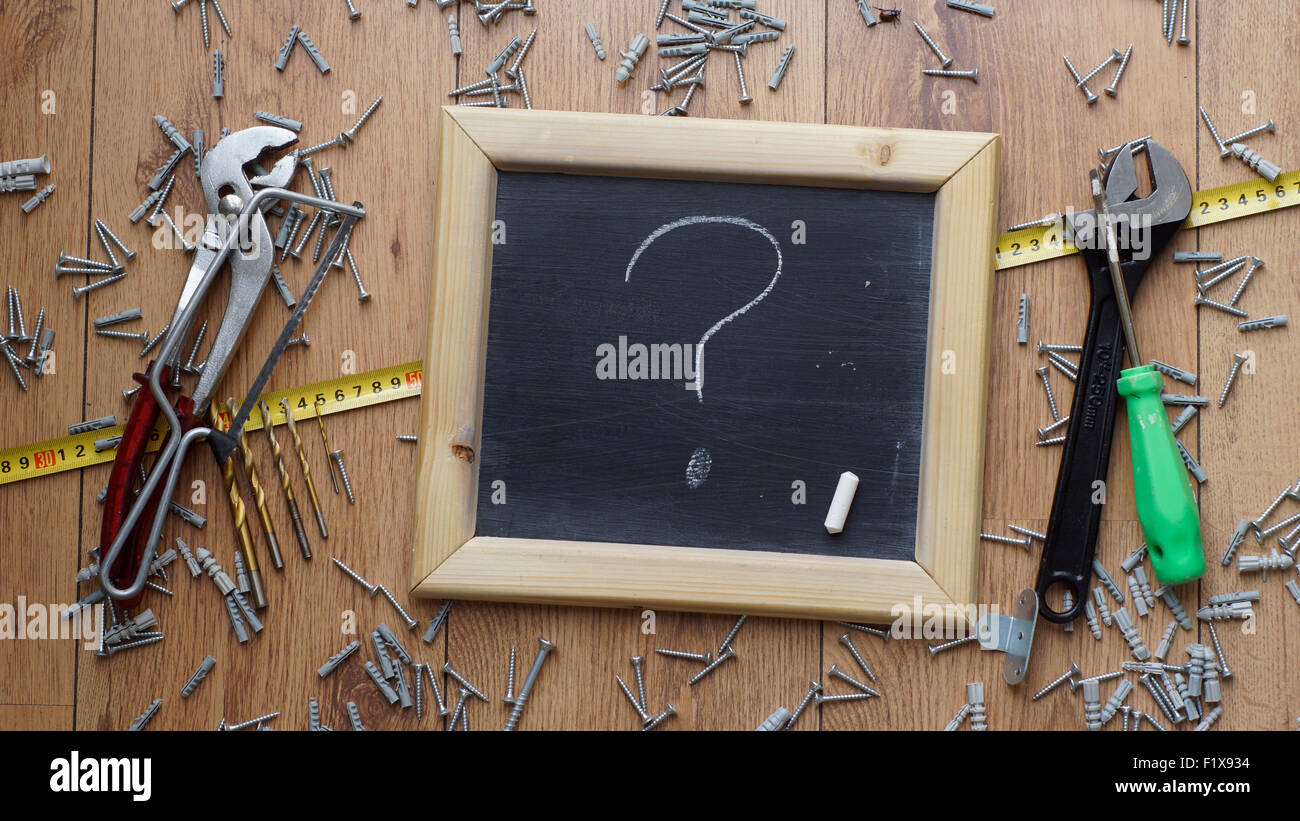 Question mark written on a chalkboard next to handyman tools Stock ...