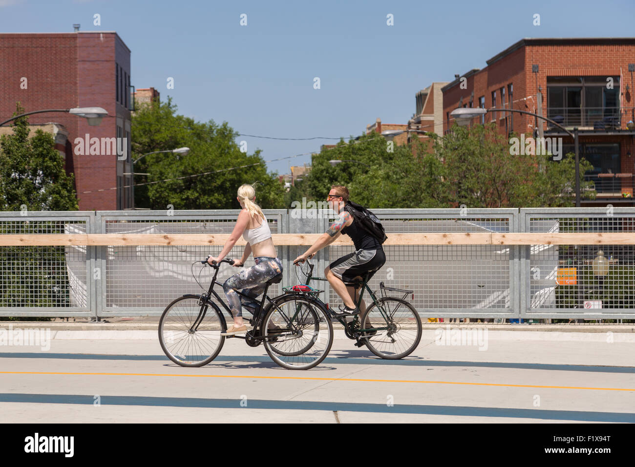 Bicyclists along the 606 elevated bike trail, green space and park ...