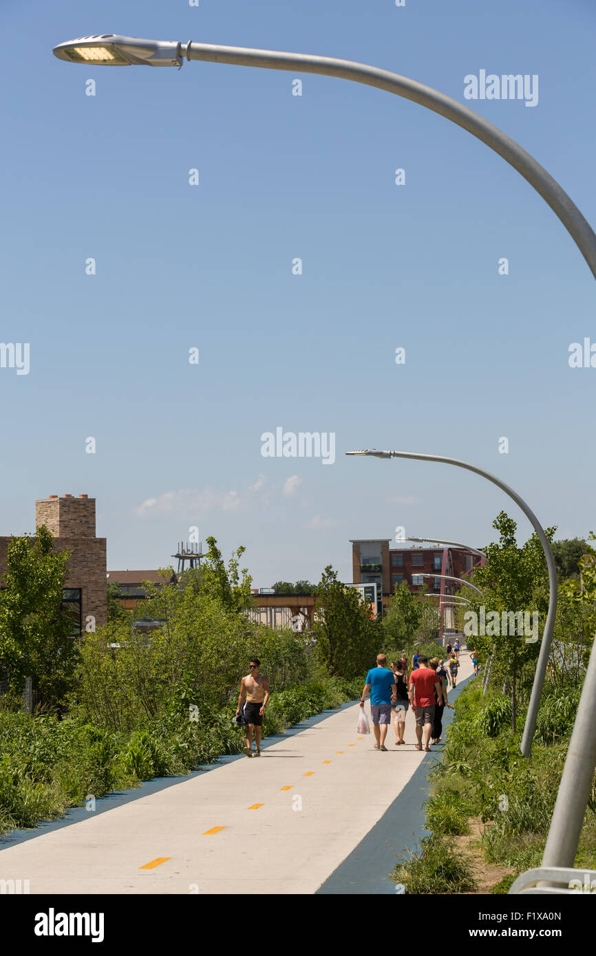 Bicyclists on the 606 elevated bike trail, green space and park built ...