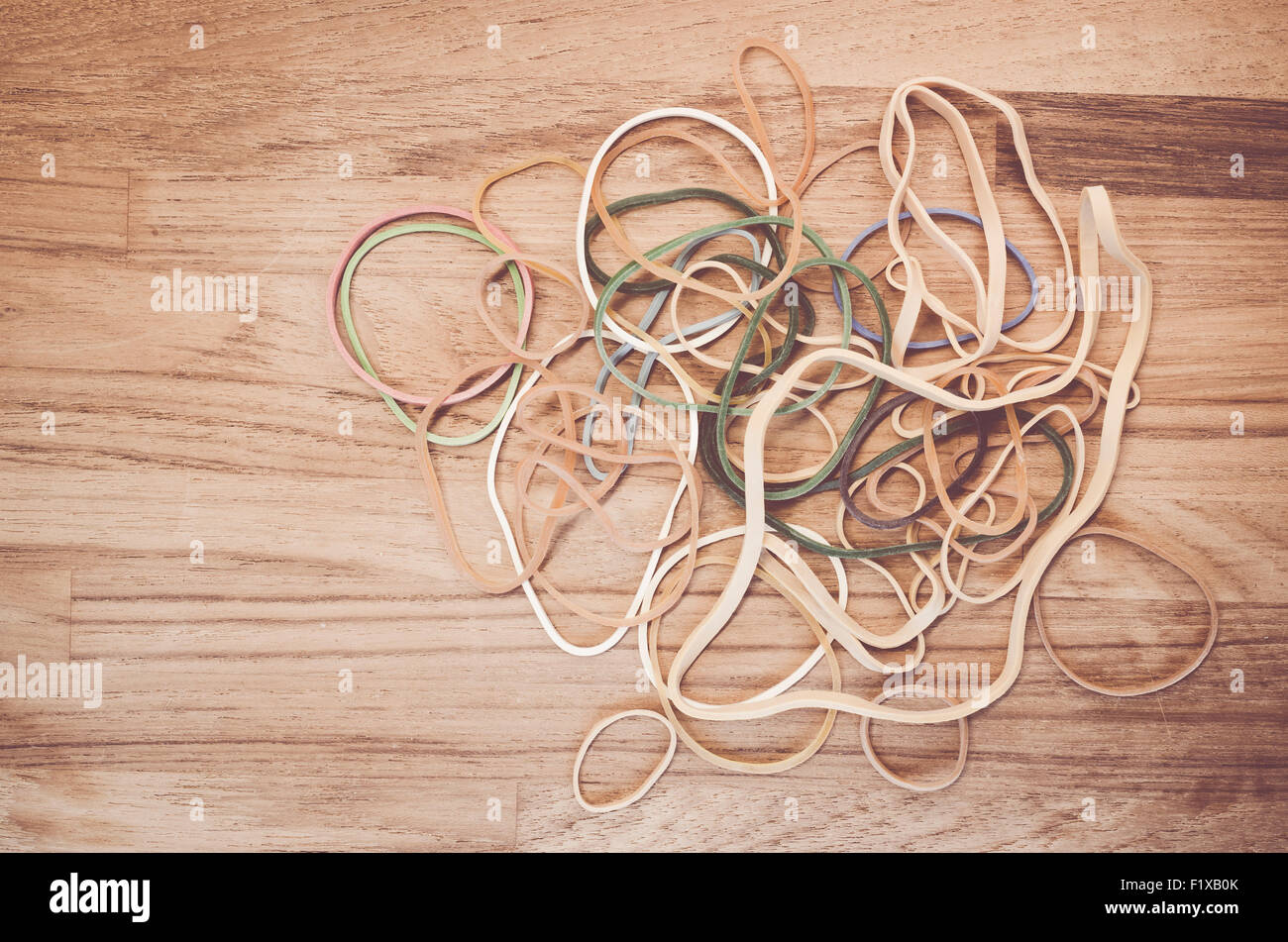 loose rubber bands on a natural wood surface Stock Photo - Alamy