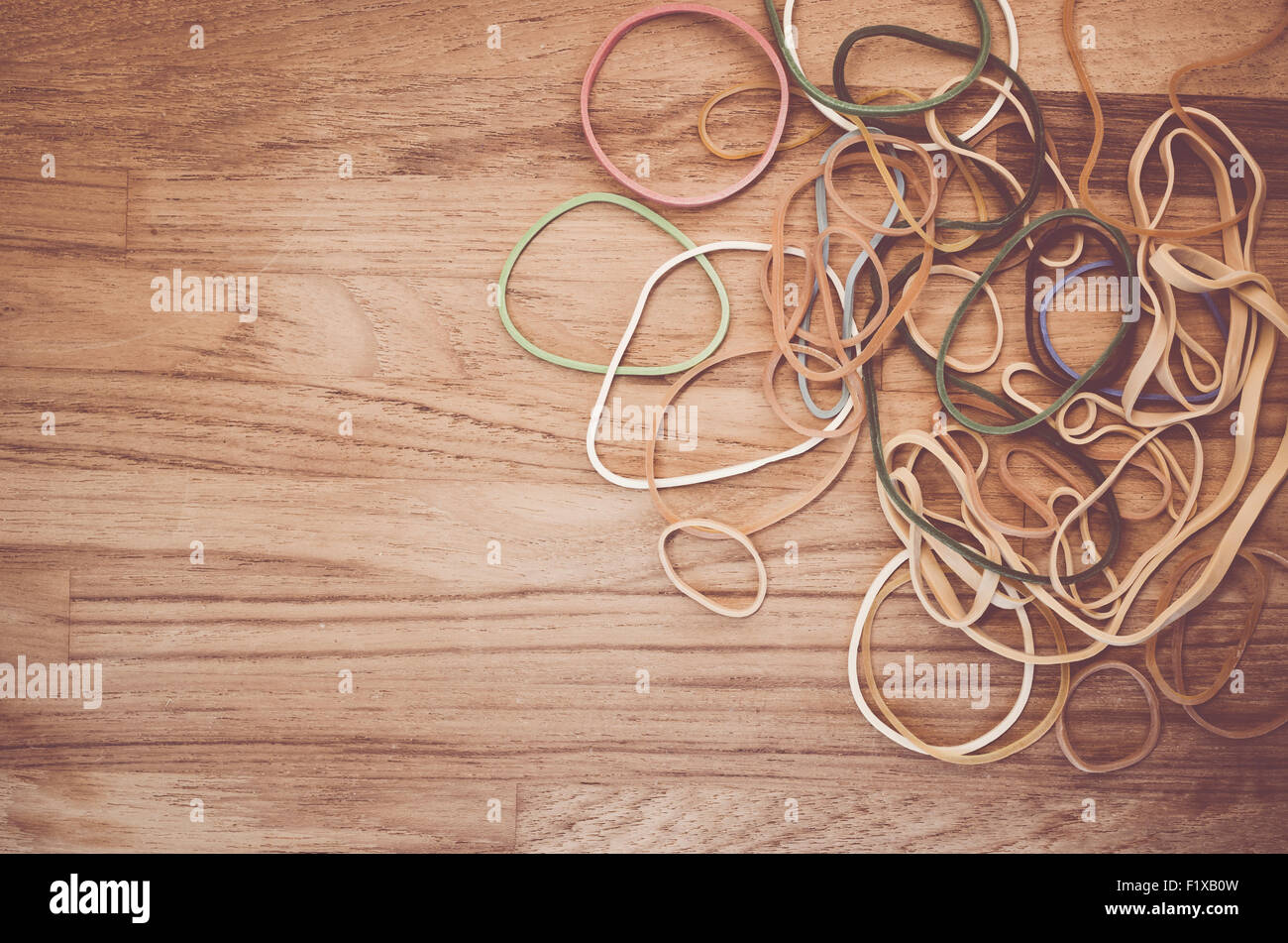 loose rubber bands on a natural wood surface Stock Photo - Alamy