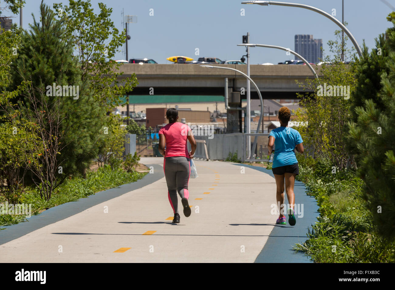 Runners along the 606 elevated bike trail, green space and park built ...