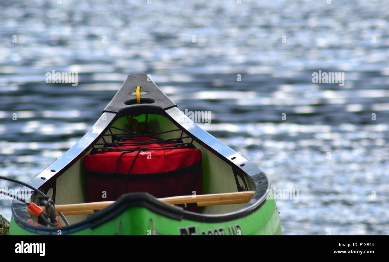 Green canoe by the lake Stock Photo - Alamy