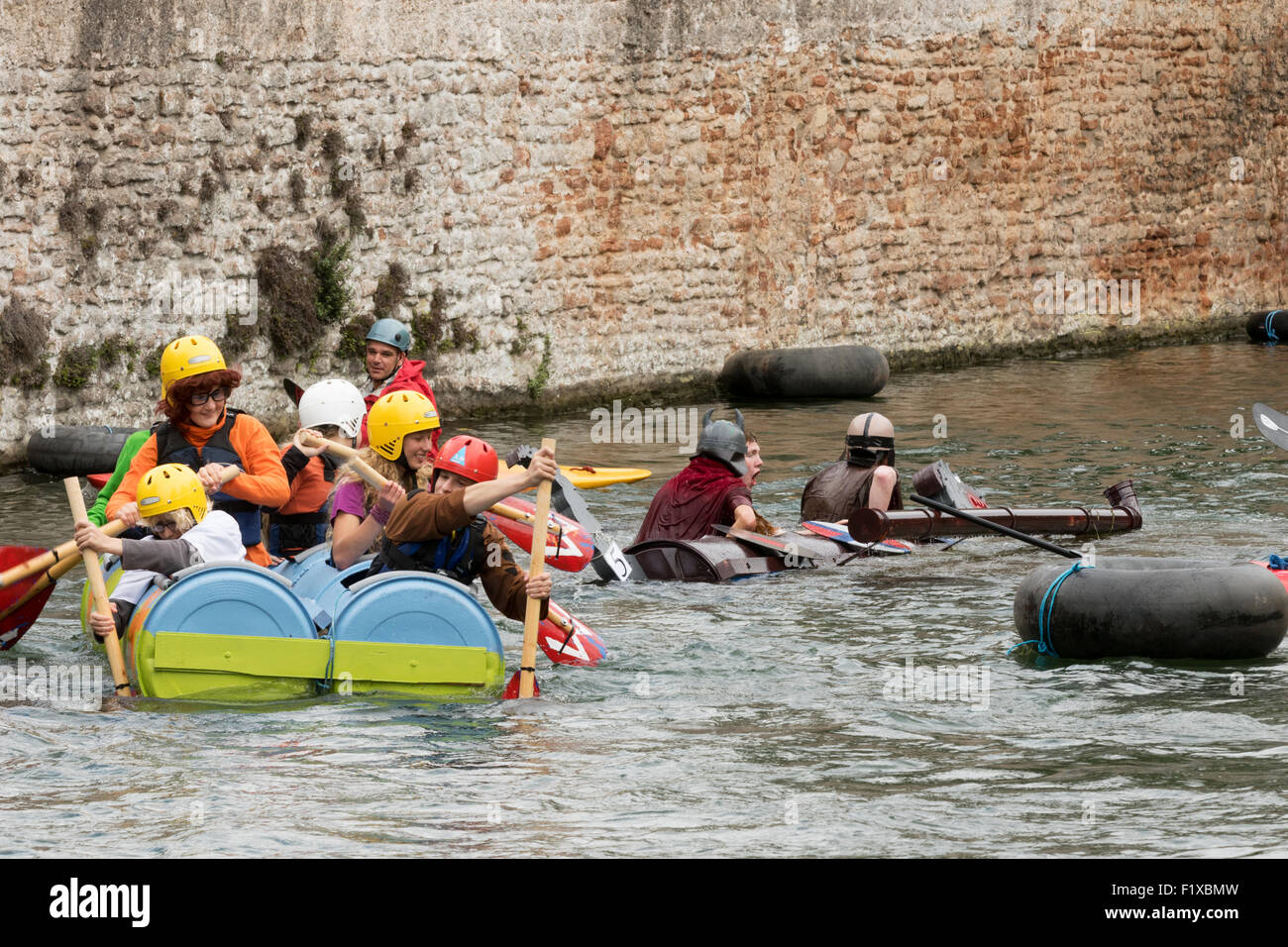 people and home made boats competing in the Wells Moat Boat race, an ...